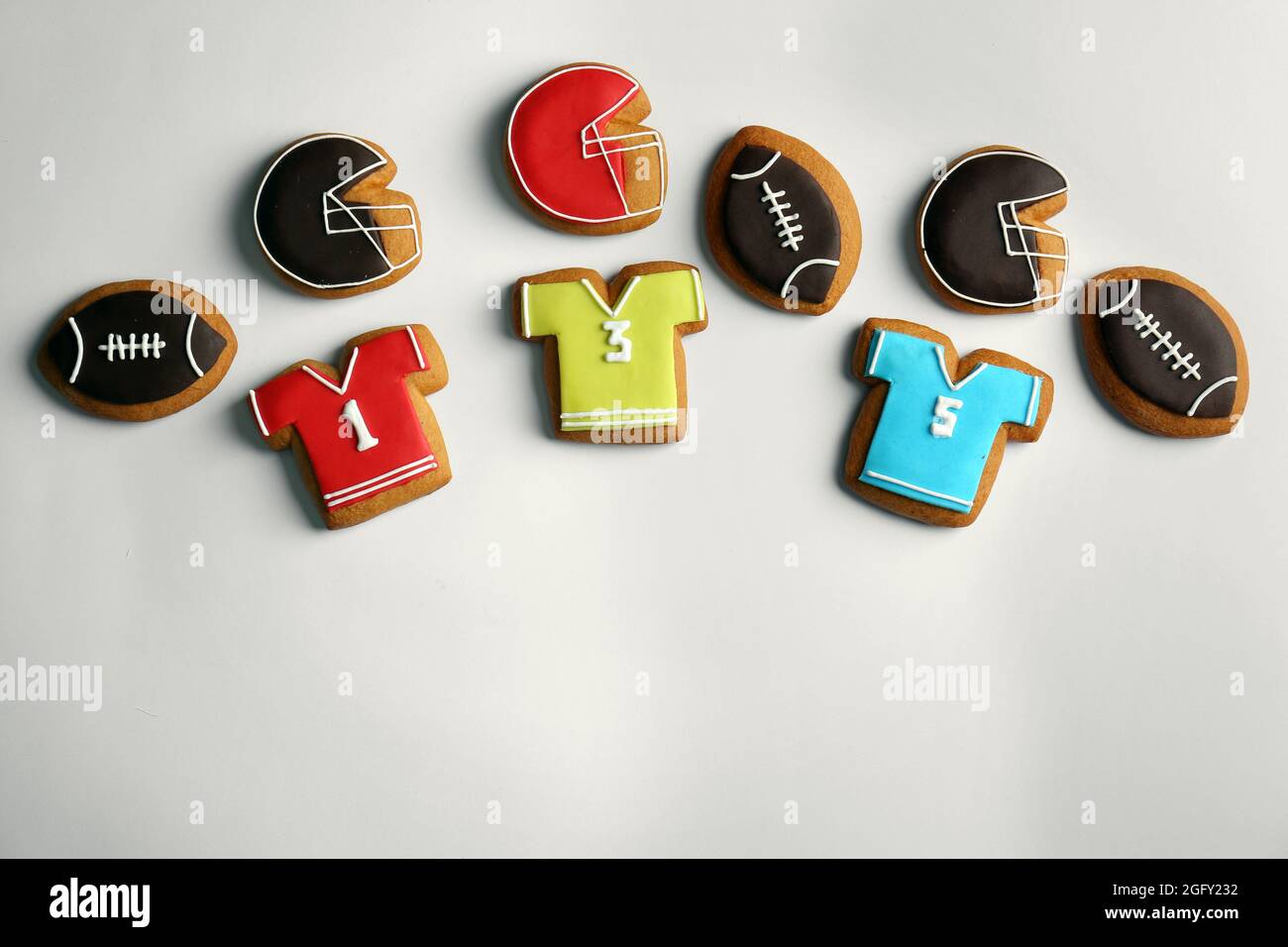 Delicious gingerbread cookies decorated with football signs on white ...