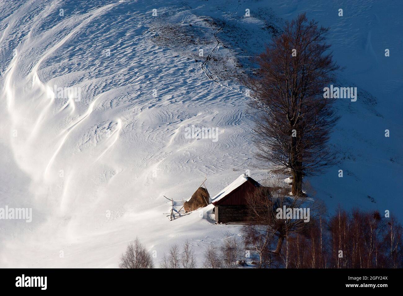 Winterscape with cottage and haystack Stock Photo - Alamy