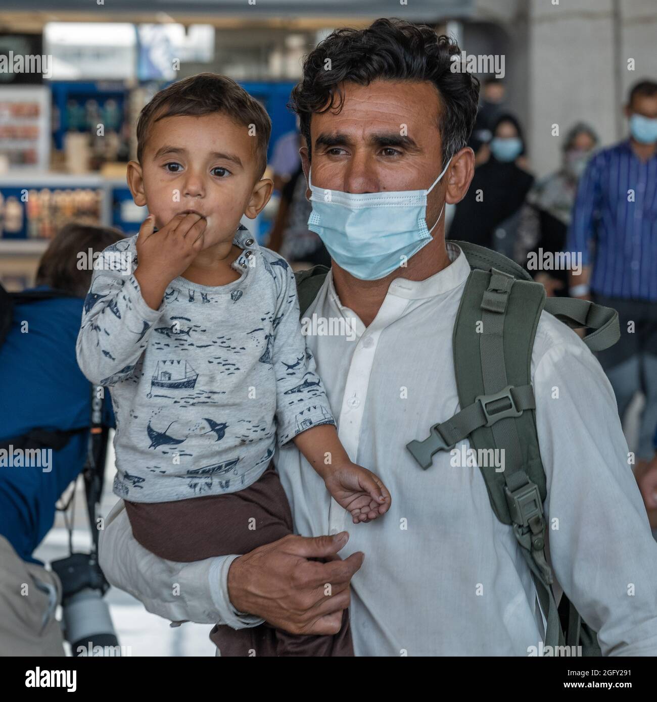 Arriving refugees evacuated from Kabul, Afghanistan board a bus that ...
