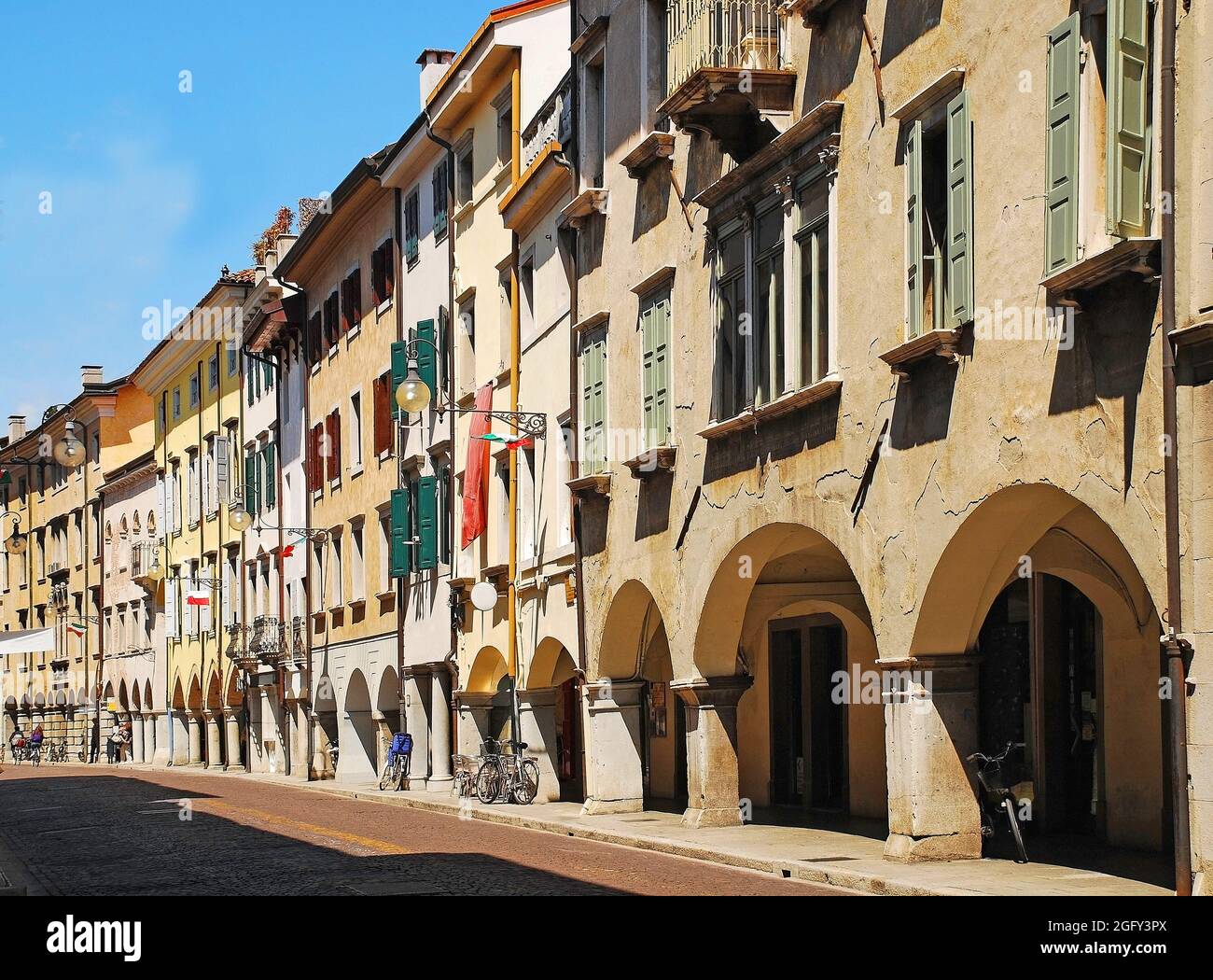 An historic road, Via Vittorio Veneto, in Udine in NE Italy. The line ...