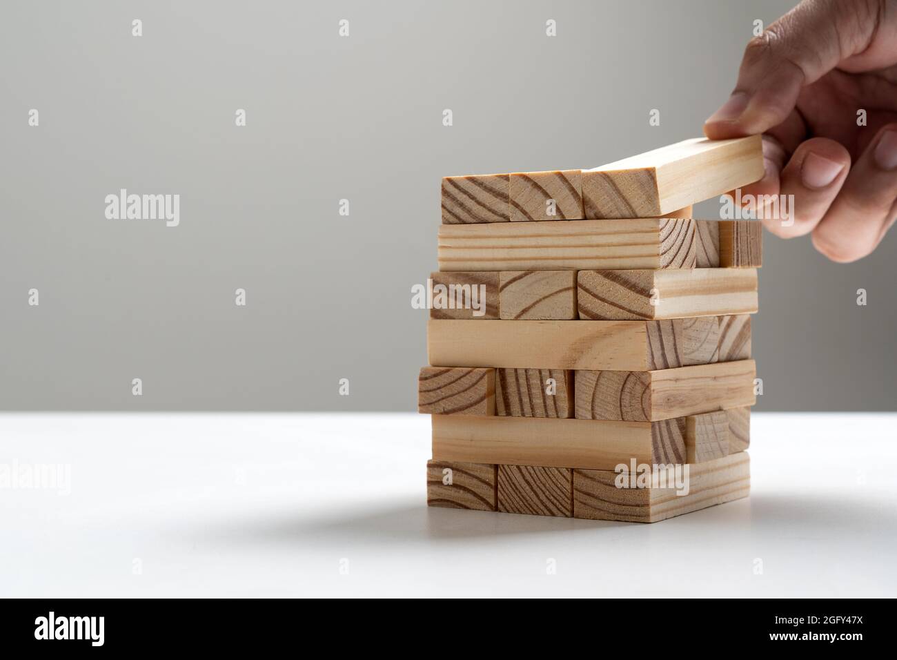 Hand of engineer stacking wood blocks Stock Photo - Alamy