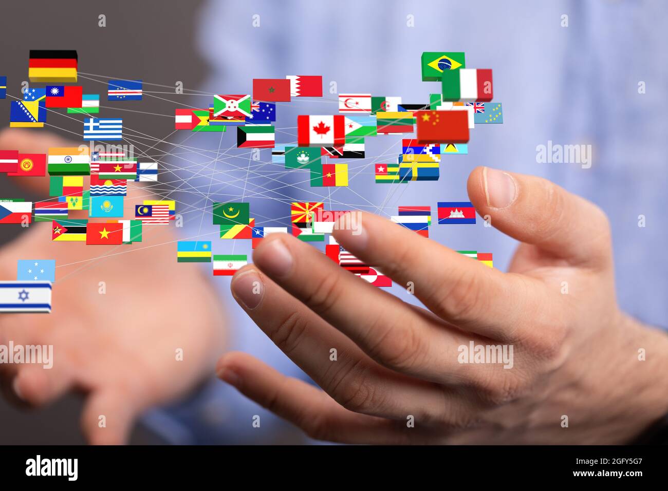 Closeup of 3D rendered flags of different countries in man's hands ...