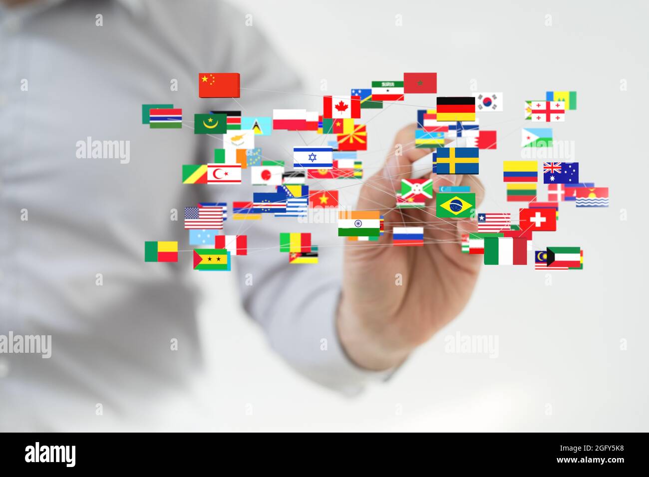 Closeup of 3D rendered flags of different countries and a man's hand ...