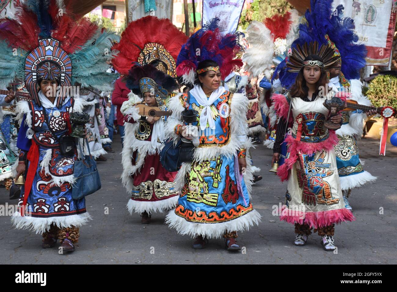 Concheros are traditional musicians and dancers who dress in ...