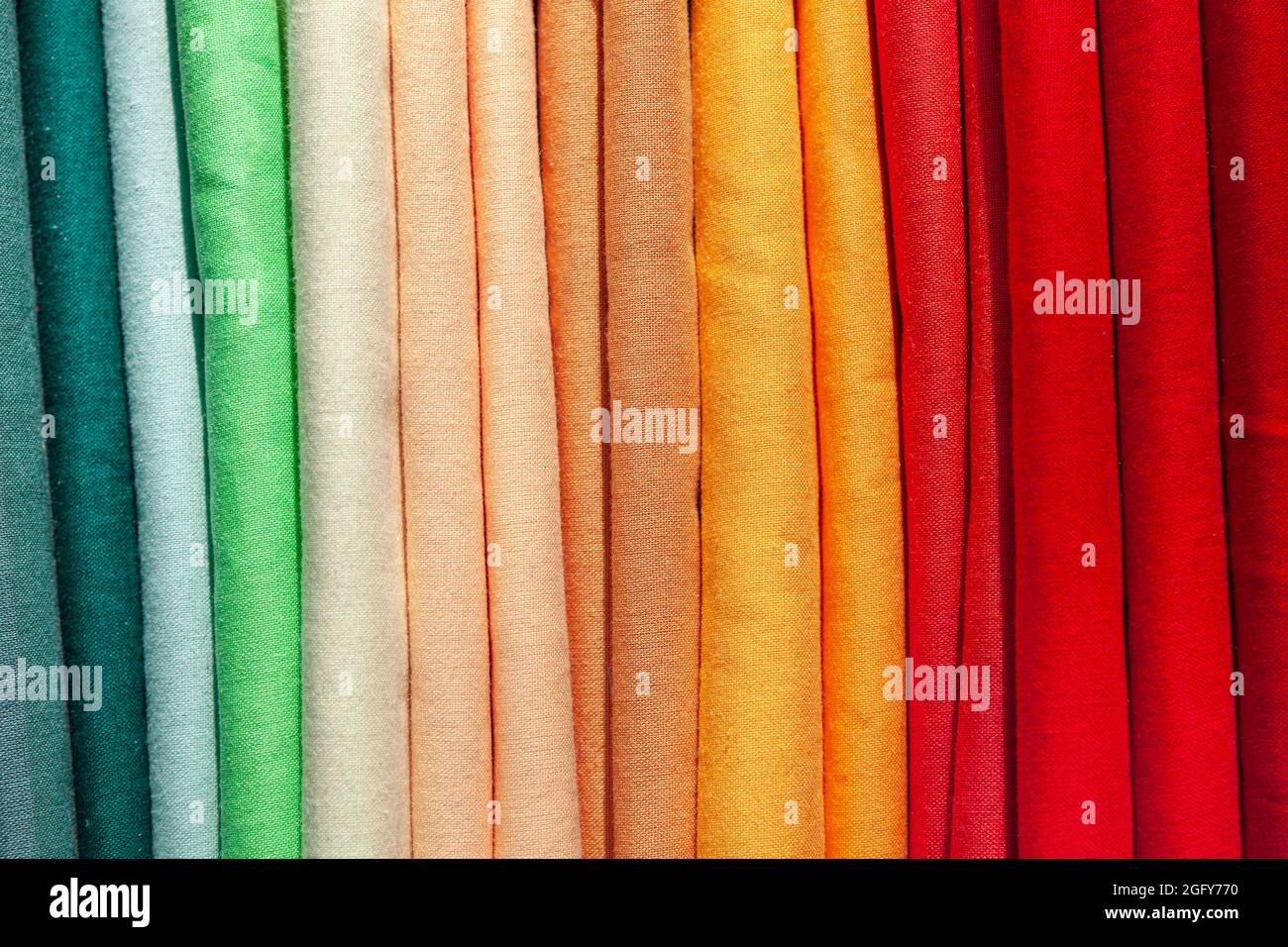 Colorful fabrics background . Stack of colourful materials for sewing ...