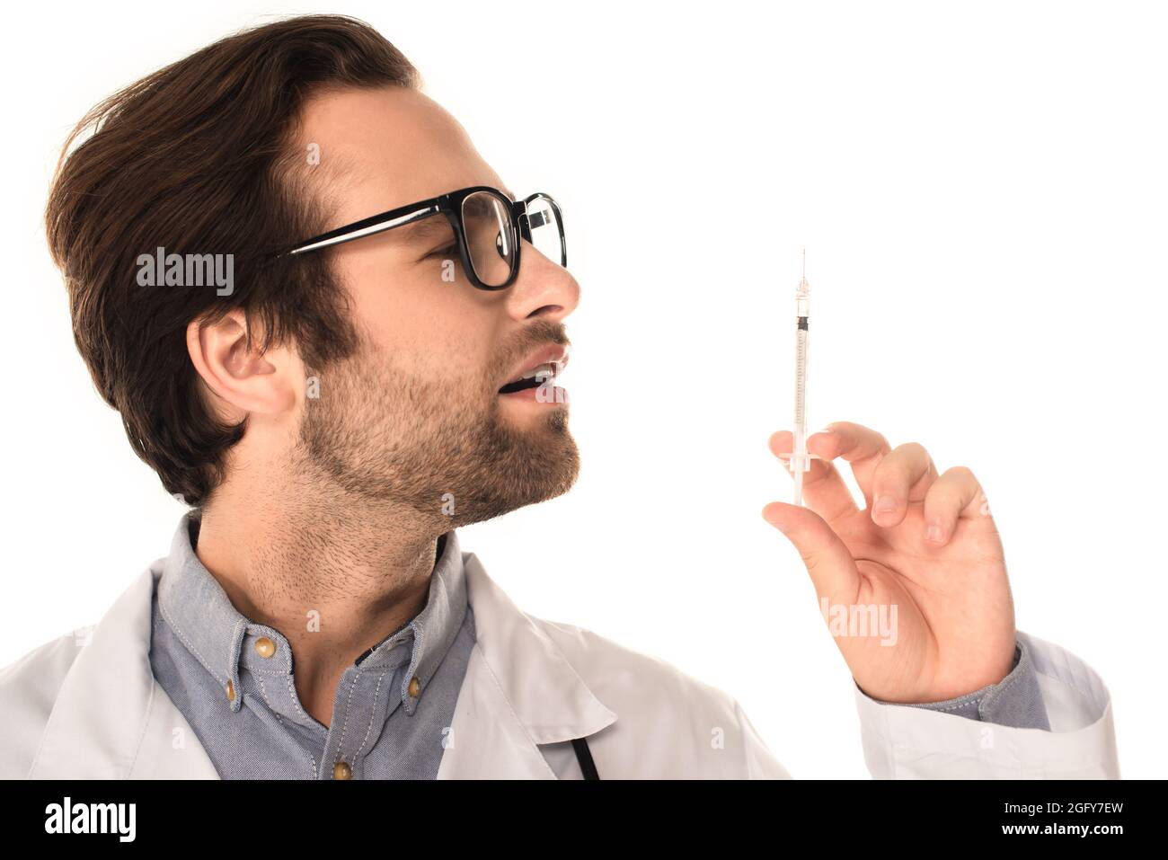 Side view of doctor looking at syringe isolated on white Stock Photo ...