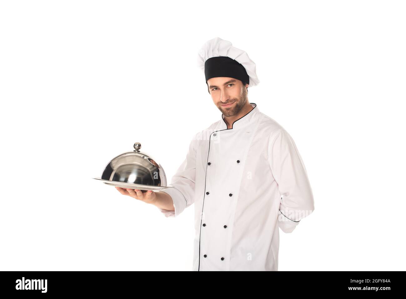 Chef in uniform holding cloche and tray isolated on white Stock Photo ...
