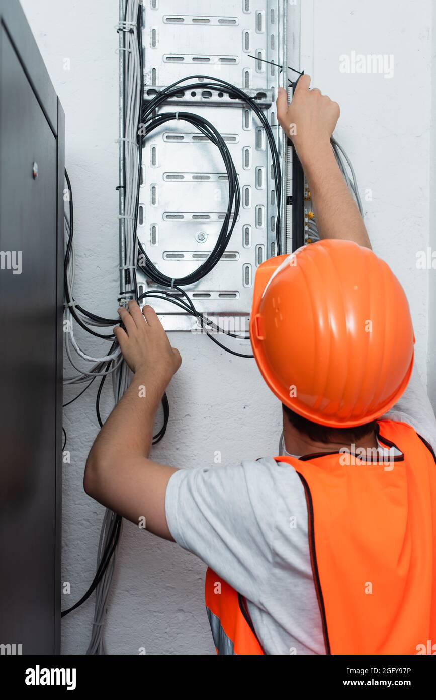 Back view of workman standing near switchboard Stock Photo - Alamy