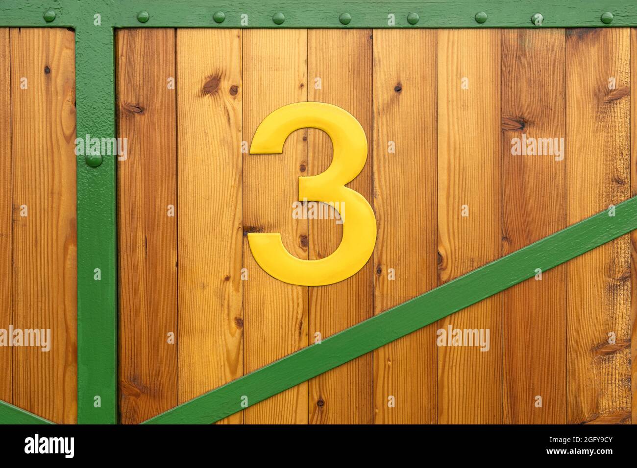 Yellow Sign Number three on wood background , indication and ...
