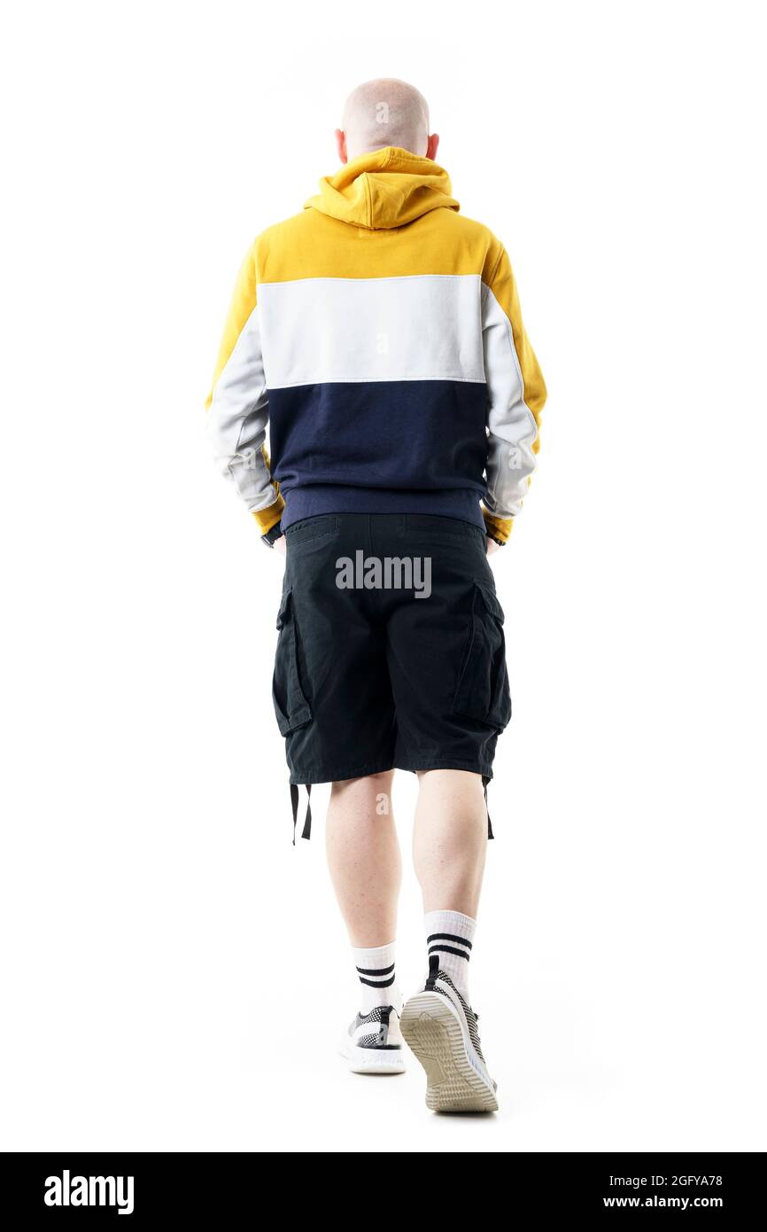 Back view of shaved bald young man in urban hip hop style clothes ...