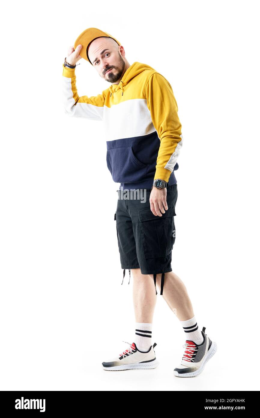 Young urban style man in hooded sweatshirt walking and greeting with ...