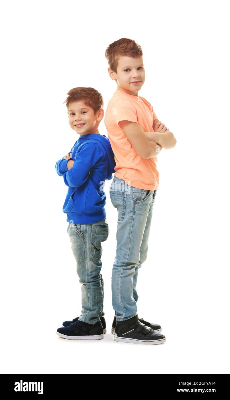 Cute little brothers standing on white background Stock Photo - Alamy