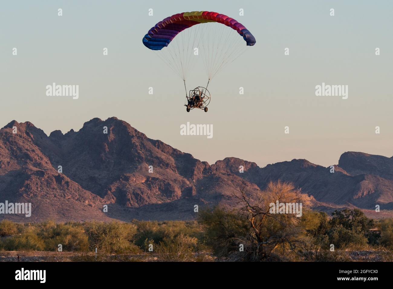 A powered parachute or PPC comes in to land in the Sonoran Desert near ...