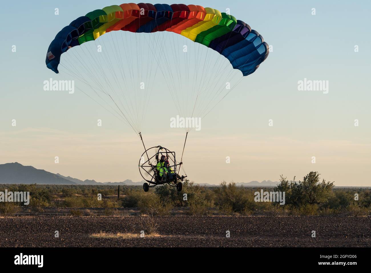 A powered parachute or PPC comes in to land in the Sonoran Desert near ...