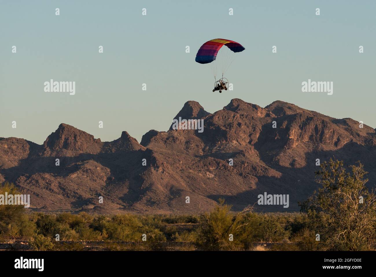 A powered parachute or PPC flies near Quartzsite, Arizona with the ...