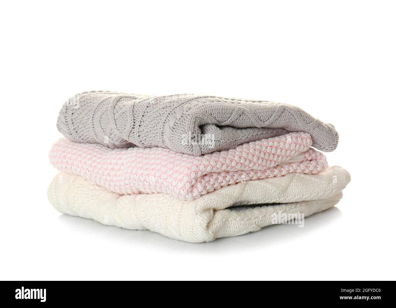 Stack of warm winter clothes on white background Stock Photo - Alamy