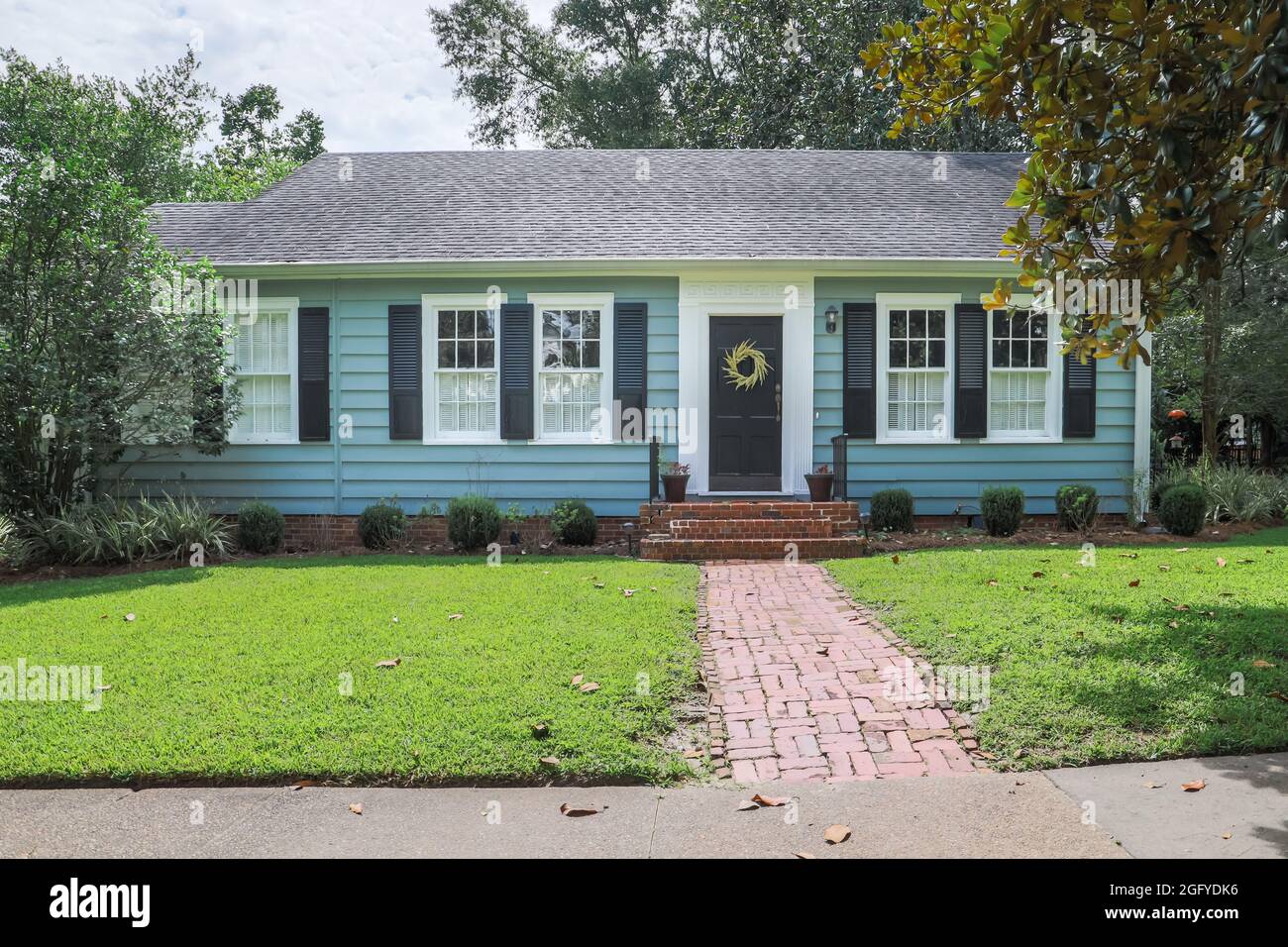 A revently renovated blue small cottage style house Stock Photo - Alamy