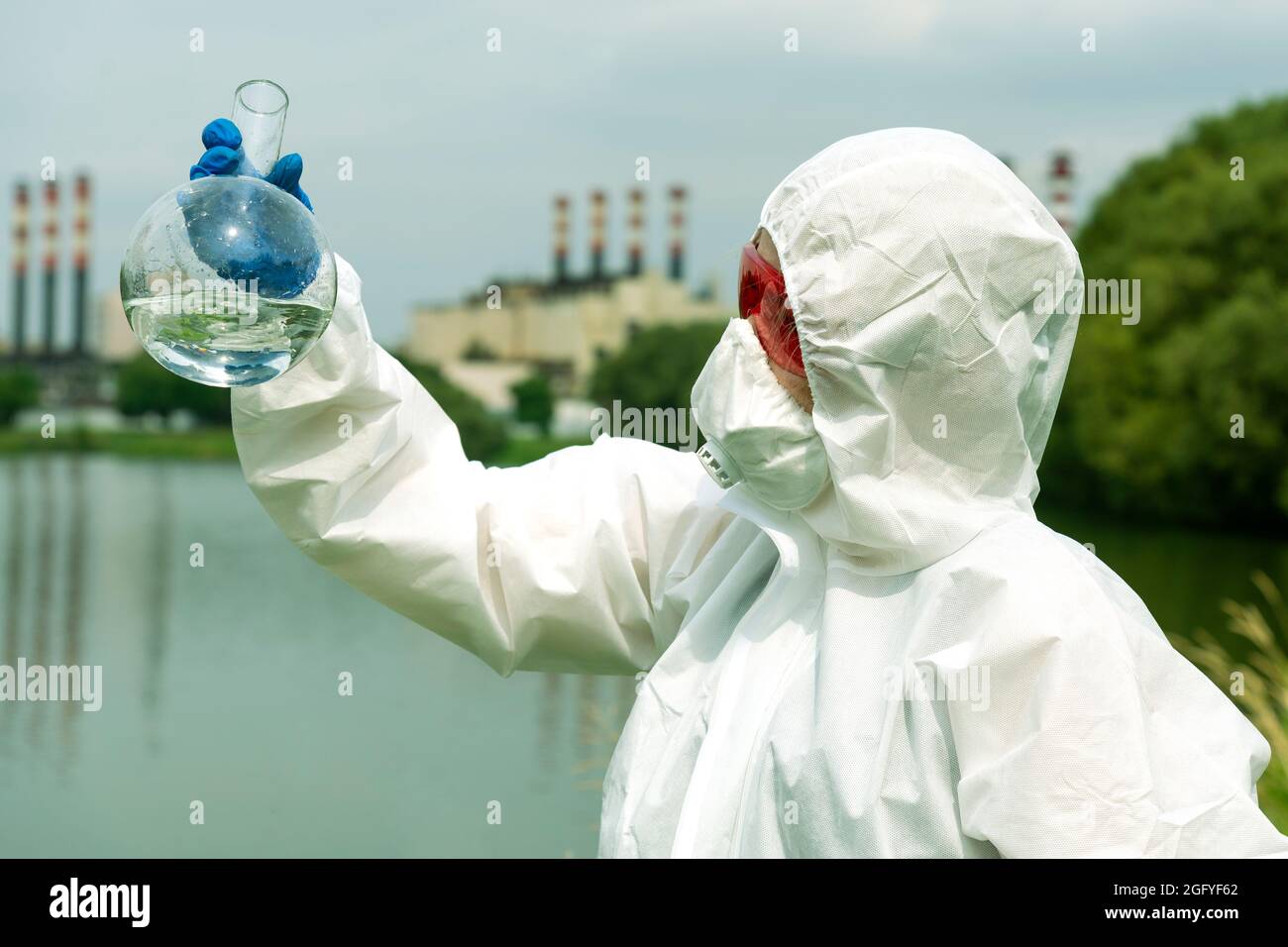 Sampling from open water. A scientist or biologist takes a water sample ...