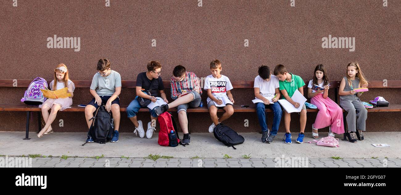 Group of elementary school kids having an outdoor class. Back to school ...