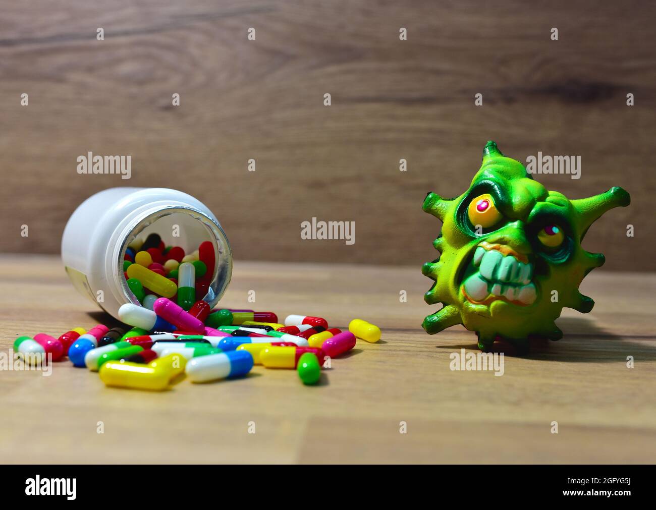 Pills from a bottle on wooden background. Assorted pharmaceutical pills ...