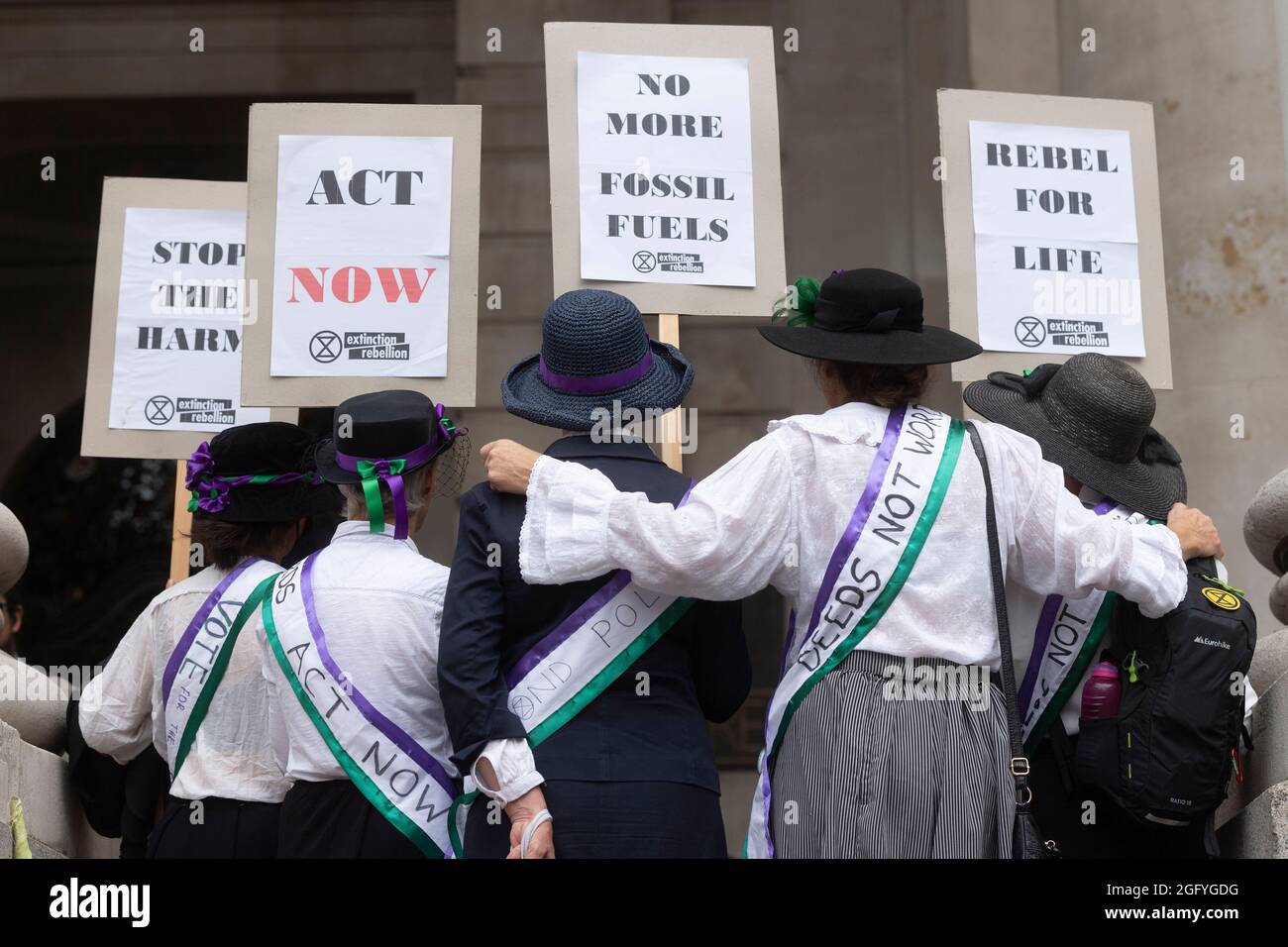 27/08/2021. London, UK. Protesters dressed as Suffragettes take part in ...