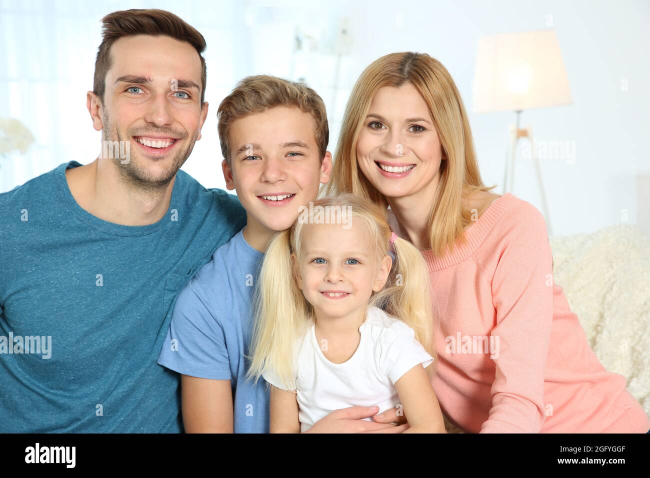 Cute happy family in living room Stock Photo - Alamy