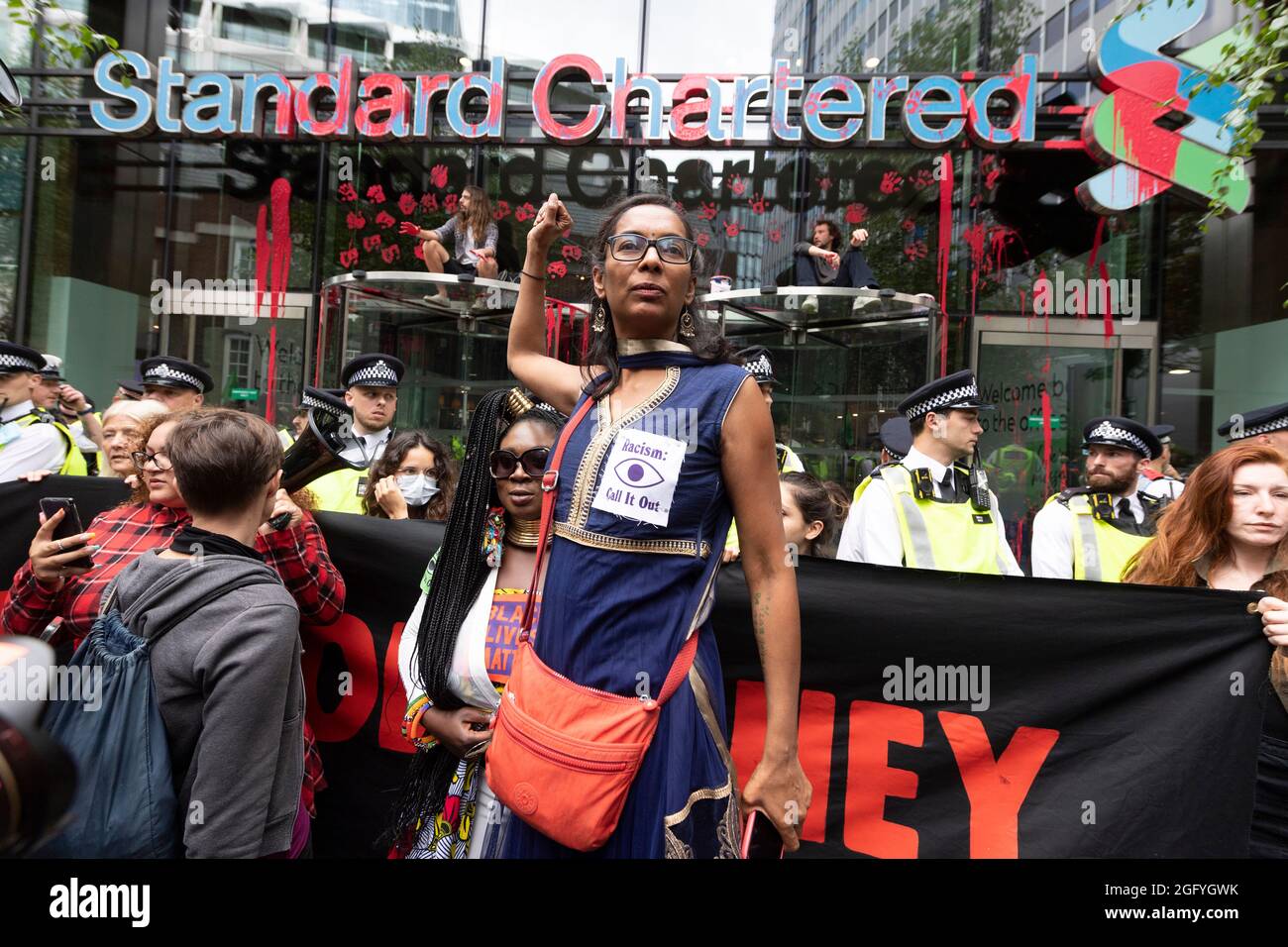 27/08/2021. London, UK. Protesters paint the Standard Chartered bank ...