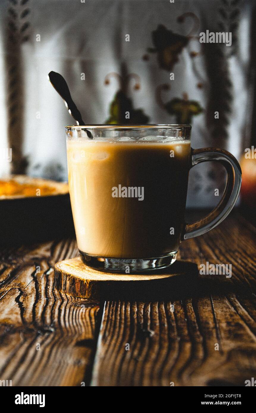 Glass of Iced Cold Brew Coffee on Wooden Coaster with a Blurred Fall ...