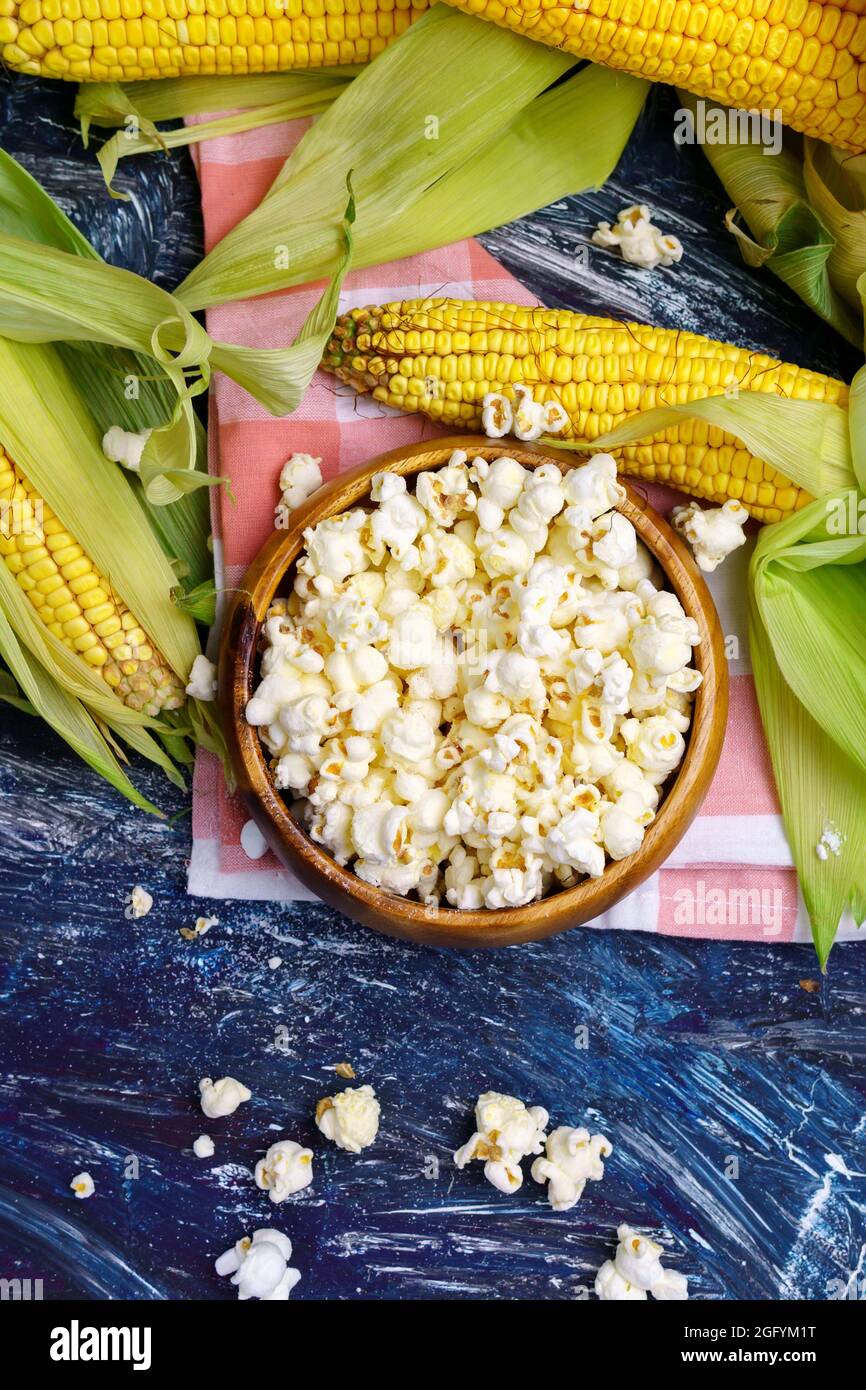 Fresh corn and popcorn on cobs on black background. Vertical photo ...