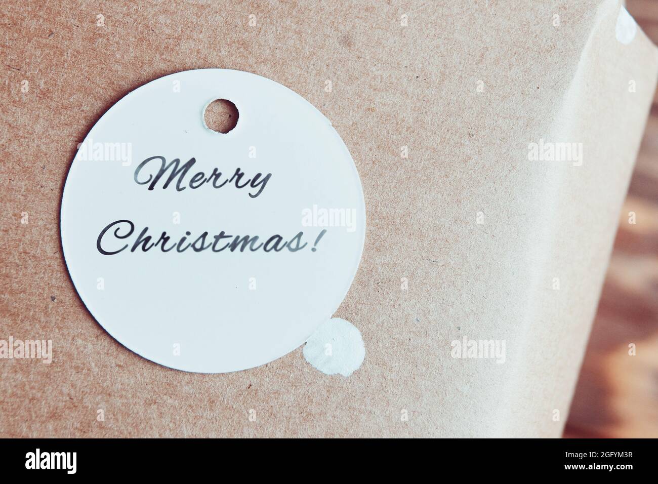 Festive label on craft paper with white polka dots. Round cardboard tag ...