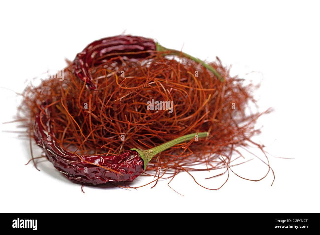 Chilli threads and chilli pod against white background Stock Photo - Alamy