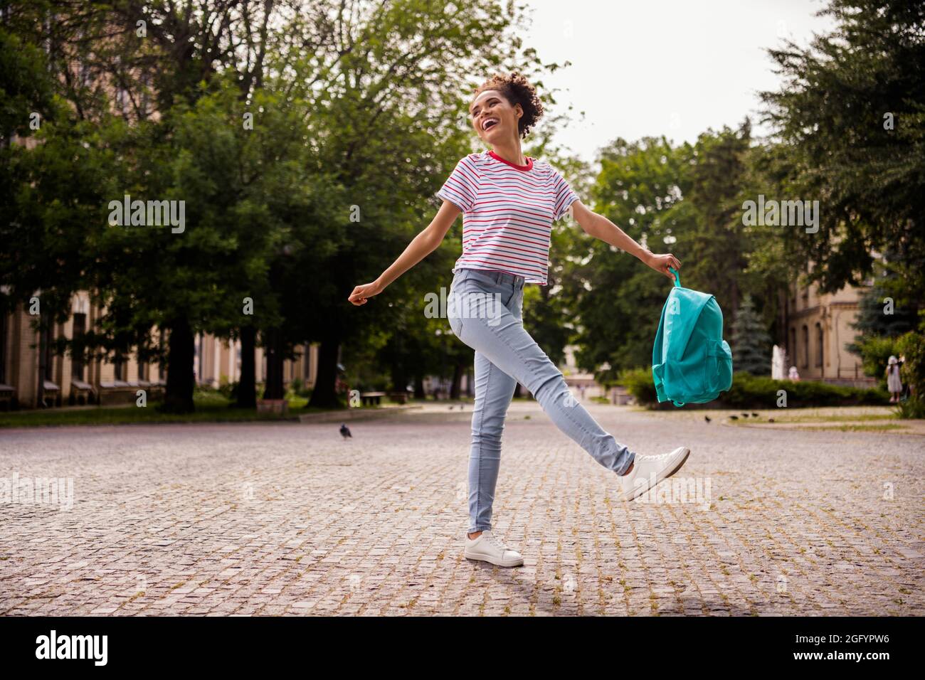 Full size photo of young afro woman happy positive smile have fun hold ...