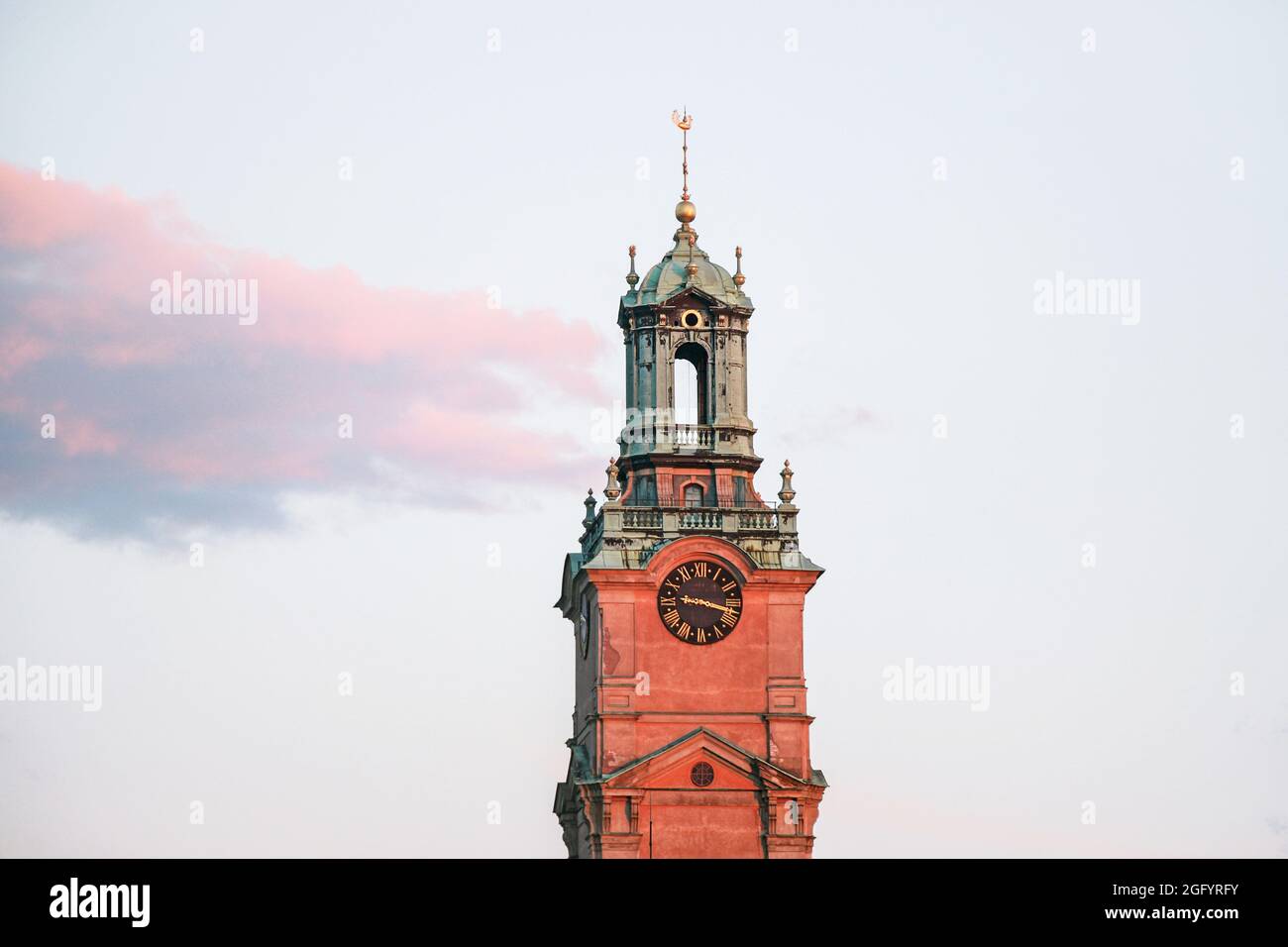 The Royal Palace clock tower in sky at sunset in Stockholm Stock Photo ...