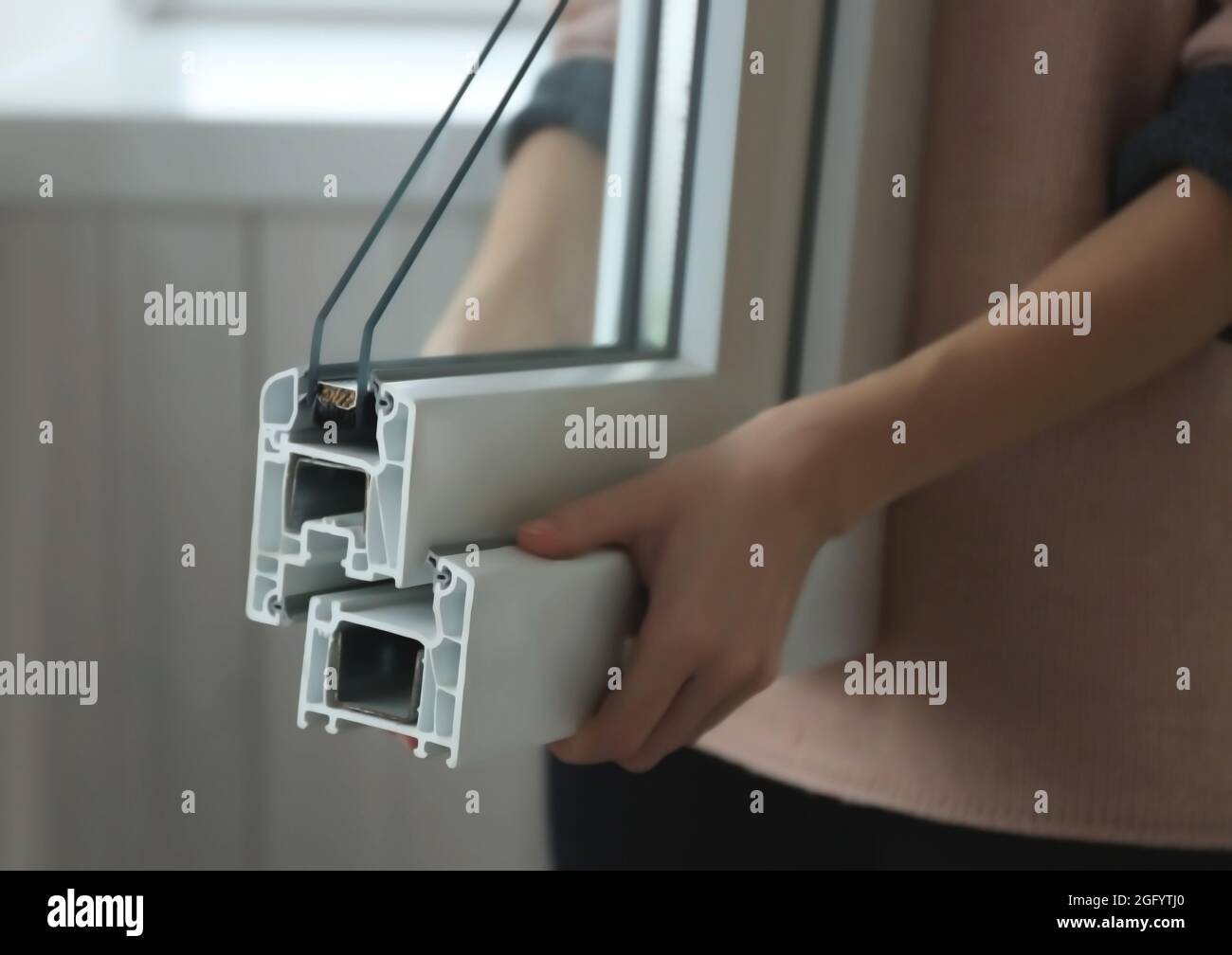 Woman holding sample of window profile, closeup Stock Photo - Alamy