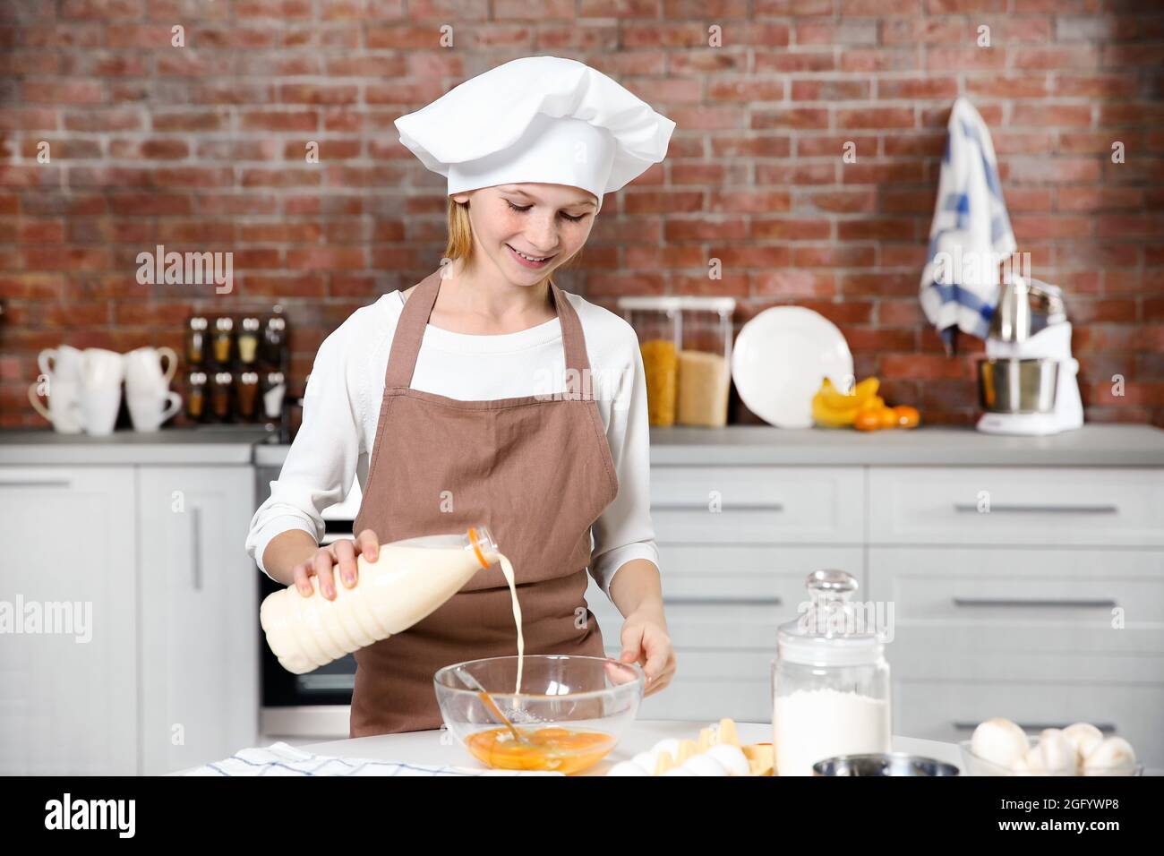Cute girl cooking in kitchen at home Stock Photo - Alamy