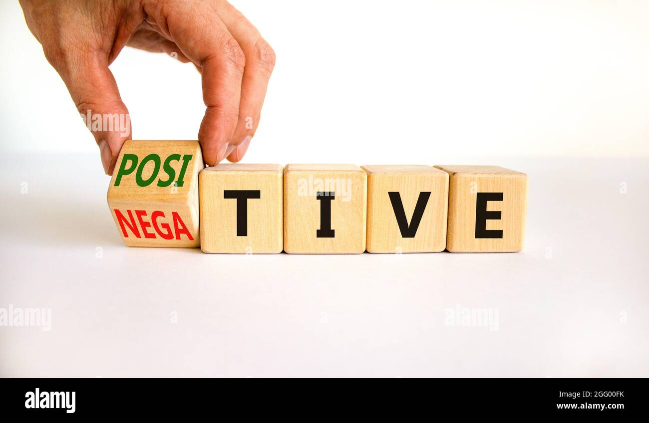Positive or negative symbol. Businessman turns a wooden cube, changes ...