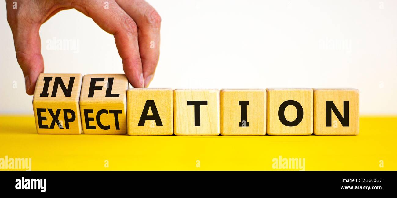 Inflation and expectation symbol. Businessman turns cubes, changes the ...