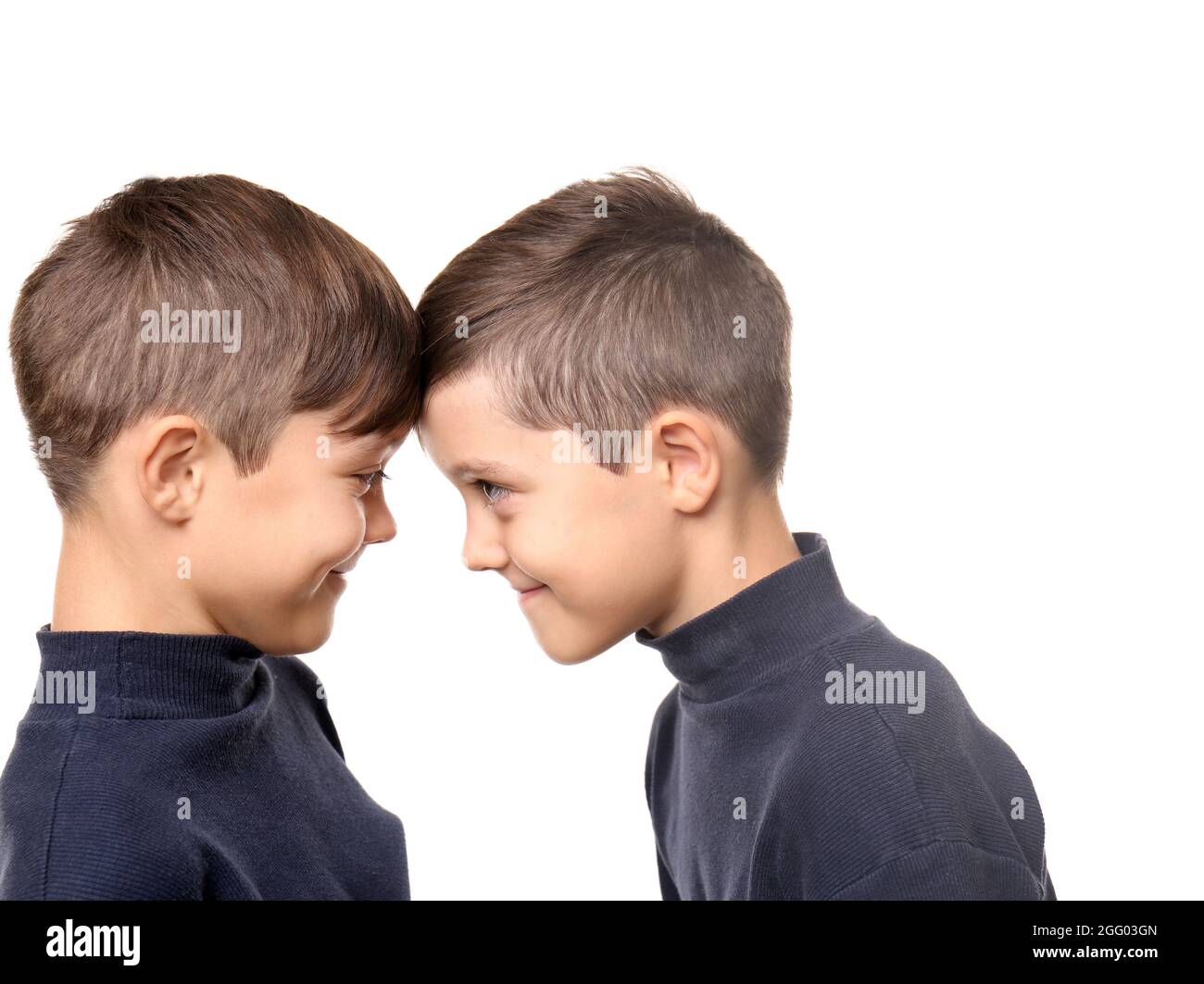 Twin brothers on white background Stock Photo - Alamy