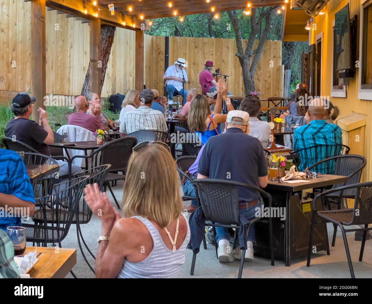 People in a restaurant enjoying musicians on stage Stock Photo - Alamy