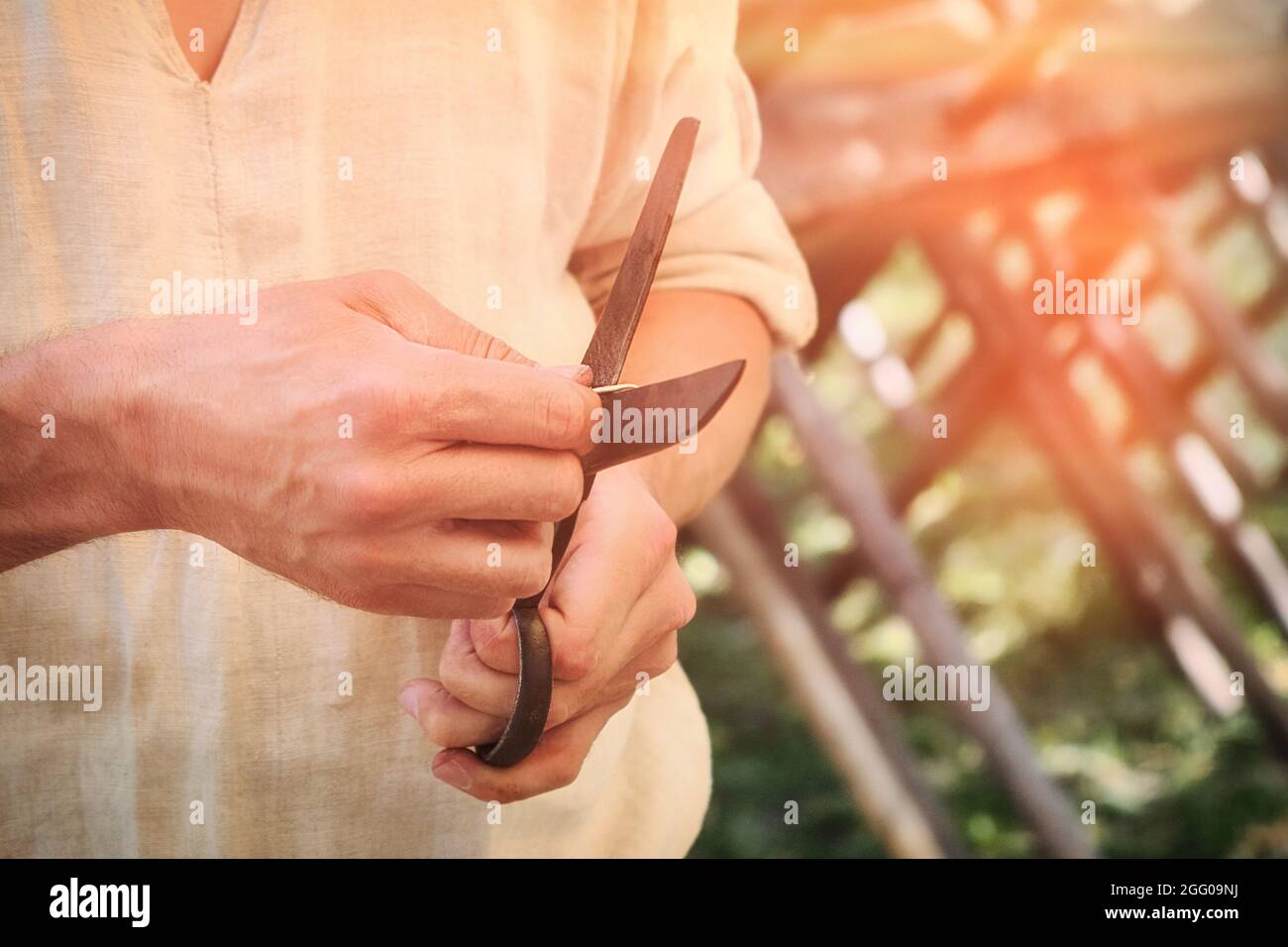 Big vintage scissors in a man hand. Cut metal to making coins. Large ...