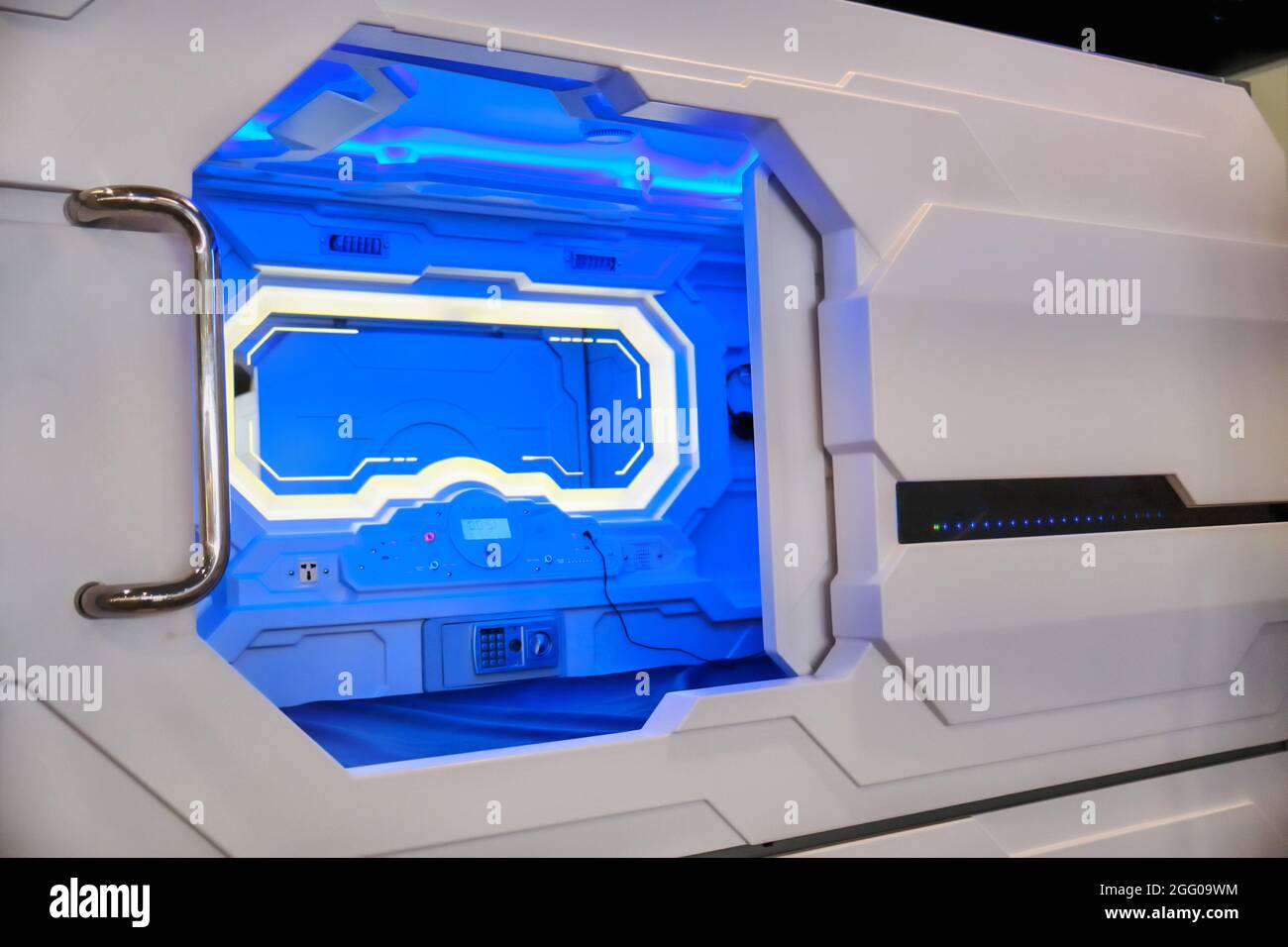 Blue light inside the room in capsule hotel. A place for the traveler ...
