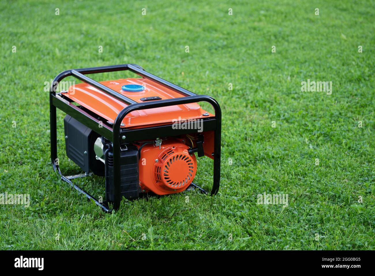 Portable electric generator on the green grass outdoors Stock Photo - Alamy