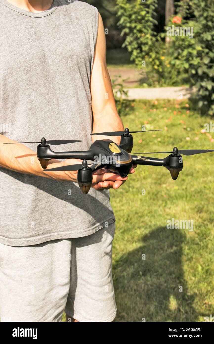 Modern small compact quadcopter in a man's hand. Launching a drone from ...