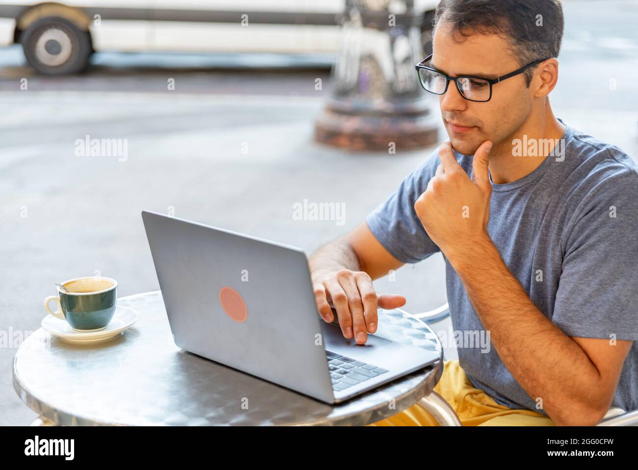 Young latin man enjoying working with computer outside Stock Photo - Alamy