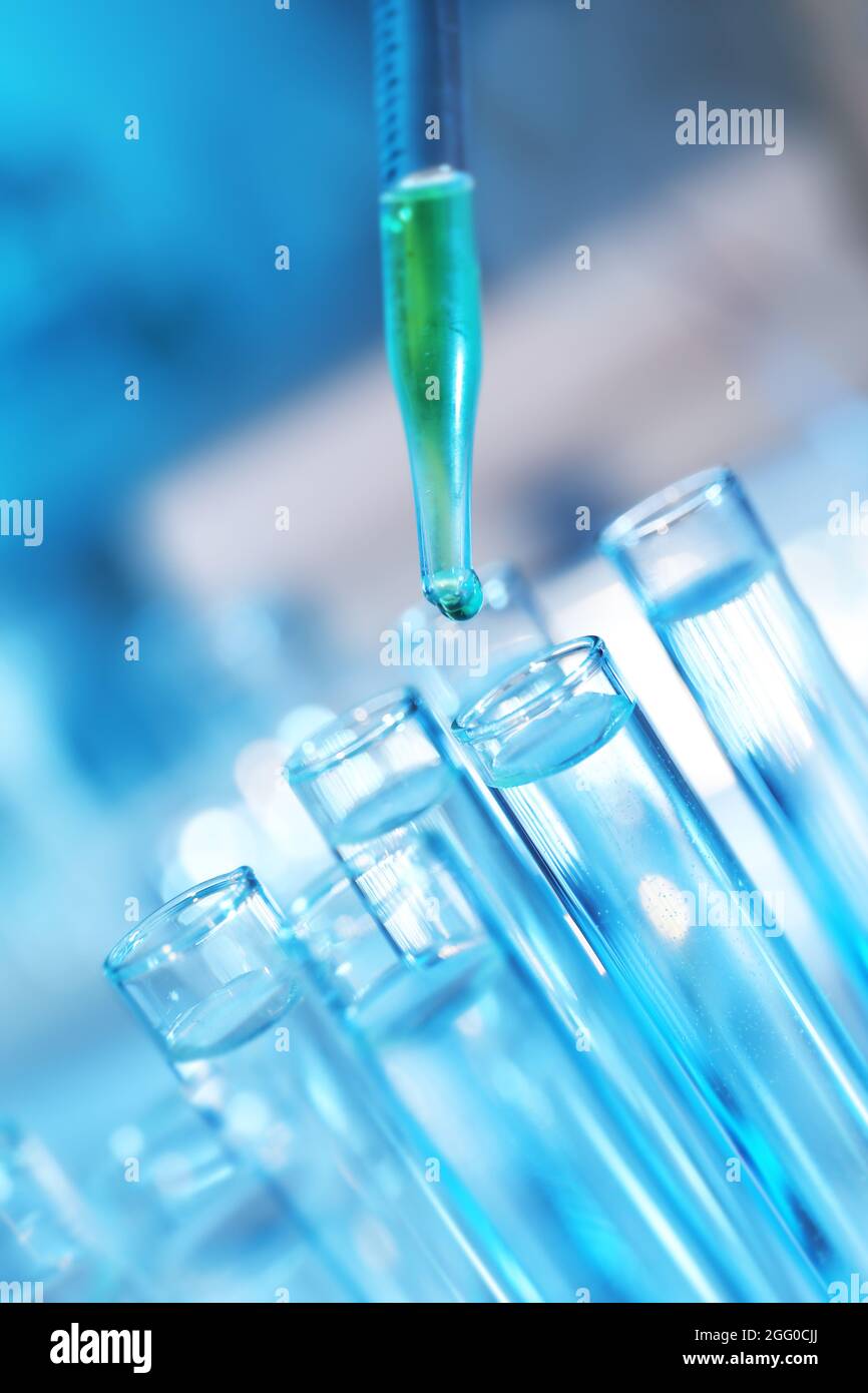 Pipette dropping a sample into a test tube, closeup Stock Photo - Alamy
