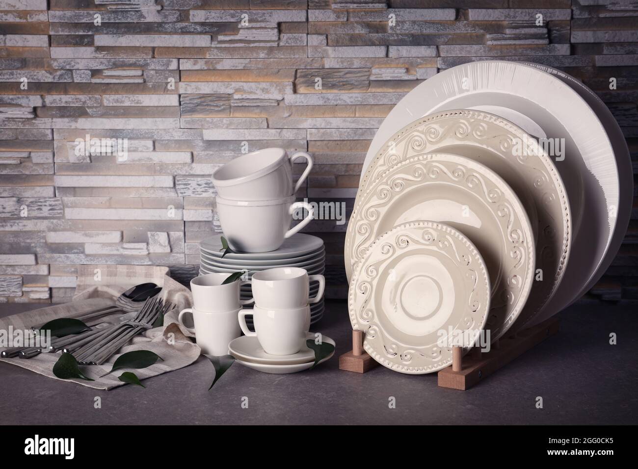 Set of rustic dinnerware on light brick background Stock Photo - Alamy