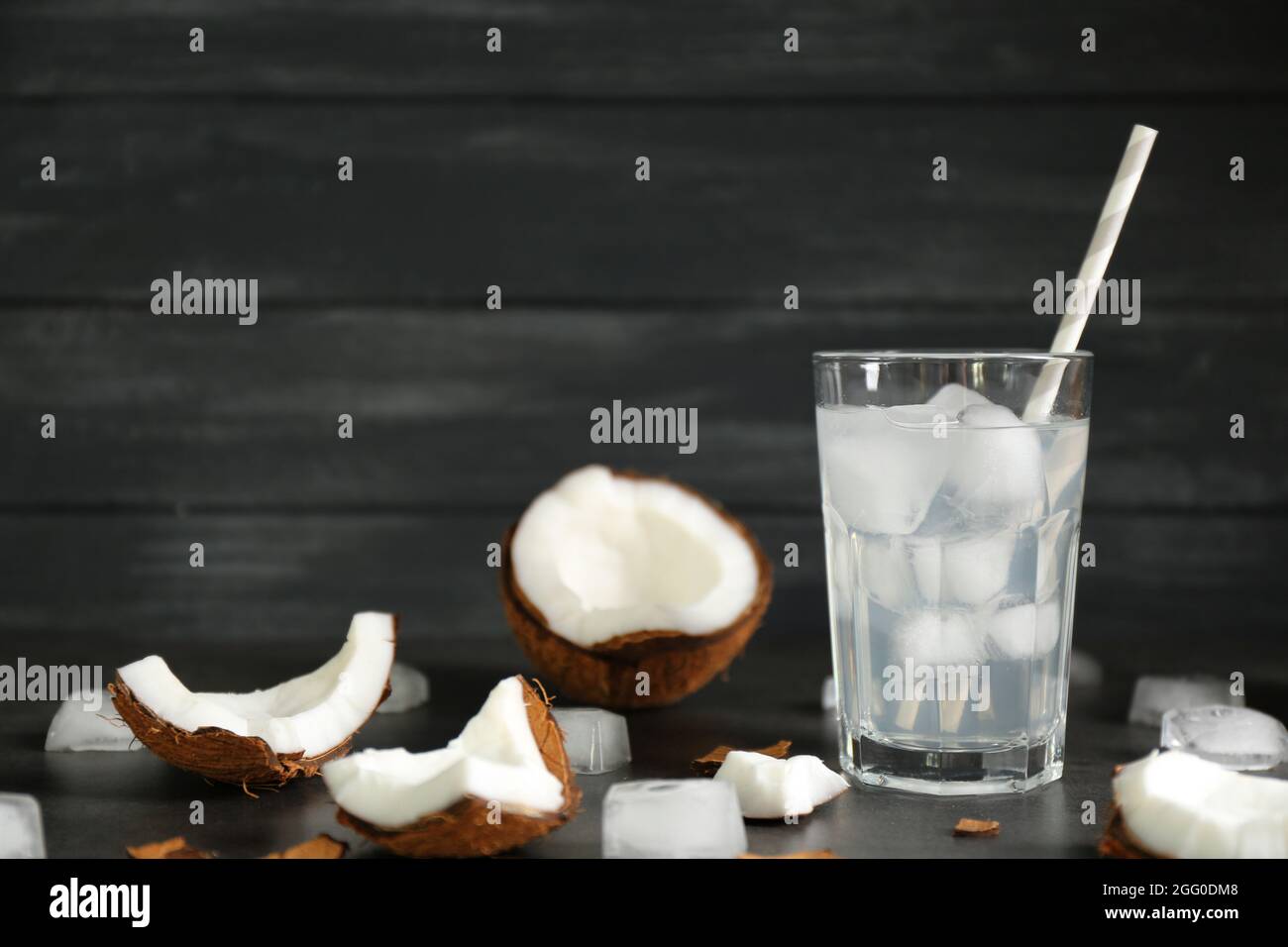 Glass of coconut water and fresh nut on dark wooden background Stock ...