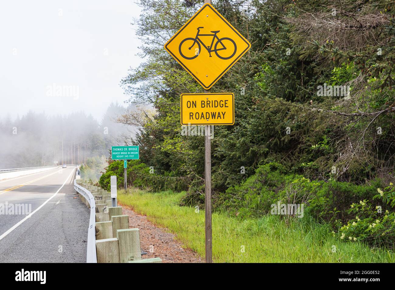 Thomas Creek Bridge, Oregon, USA. Bikes on the road sign at the Thomas ...