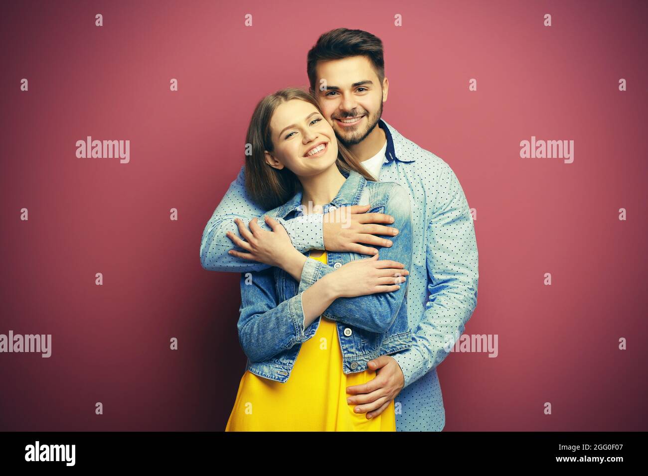Cute young couple on color background Stock Photo - Alamy