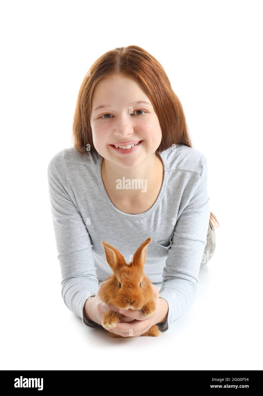 Cute girl holding small rabbit on white background Stock Photo - Alamy